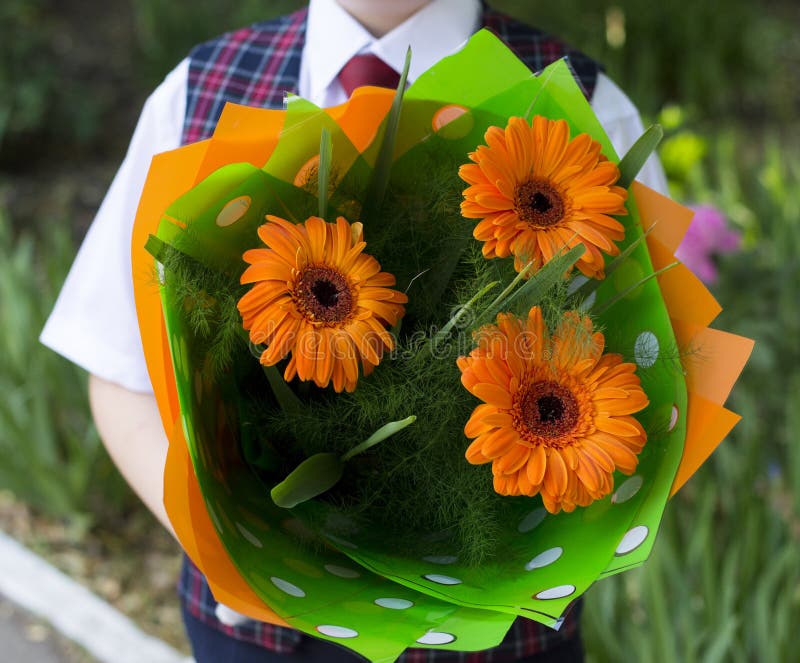 The School Student with Flowers, a Close Up, Flowers in the Center ...
