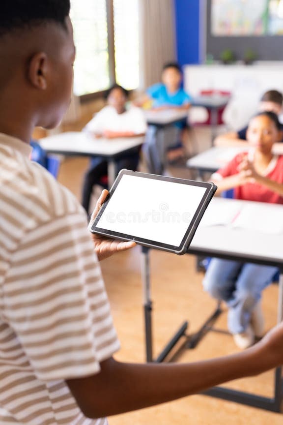 In School, Student Presenting Using Tablet in Classroom with Classmates ...