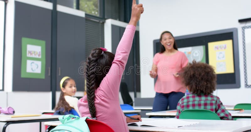 In School, Student Raising Hand To Ask Question while Teacher Smiles ...
