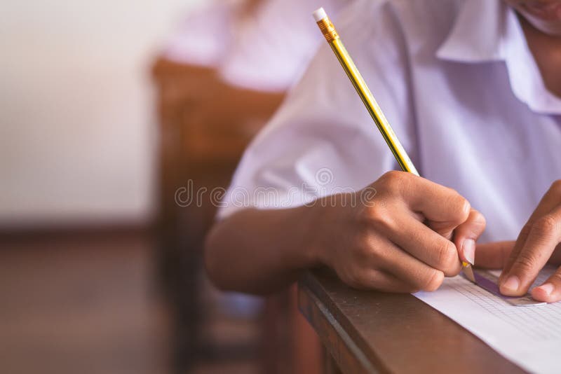 School Student is Taking Exam and Writing Answer in Classroom for ...
