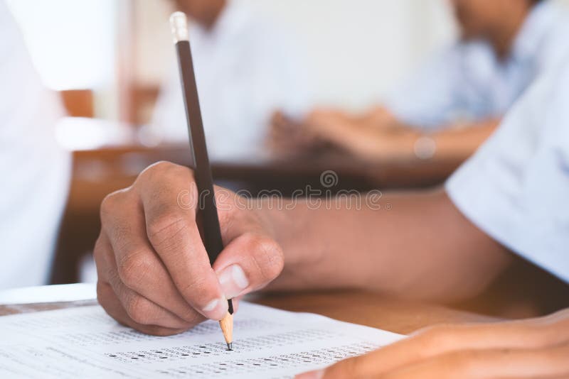 School Student is Taking Exam and Writing Answer in Classroom for ...
