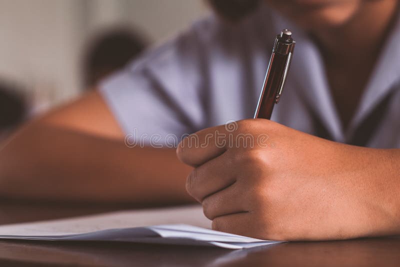 School Student is Taking Exam and Writing Answer in Classroom for ...