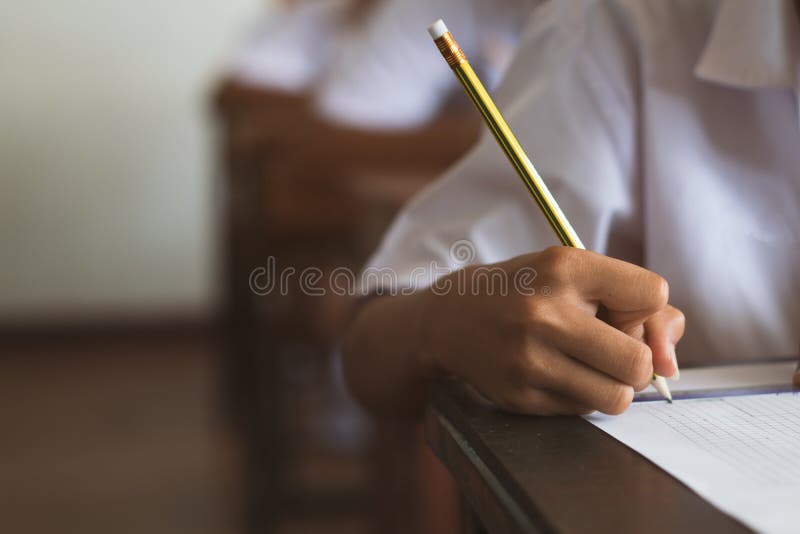 School Student is Taking Exam and Writing Answer in Classroom for ...