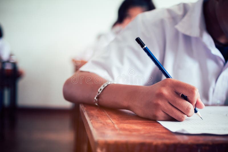 School Student is Taking Exam and Writing Answer in Classroom for ...
