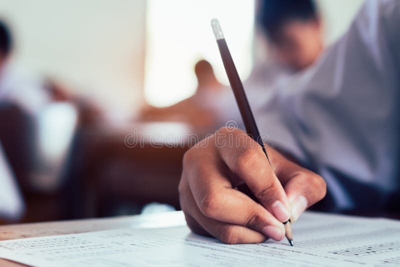 School Student is Taking Exam and Writing Answer in Classroom for ...