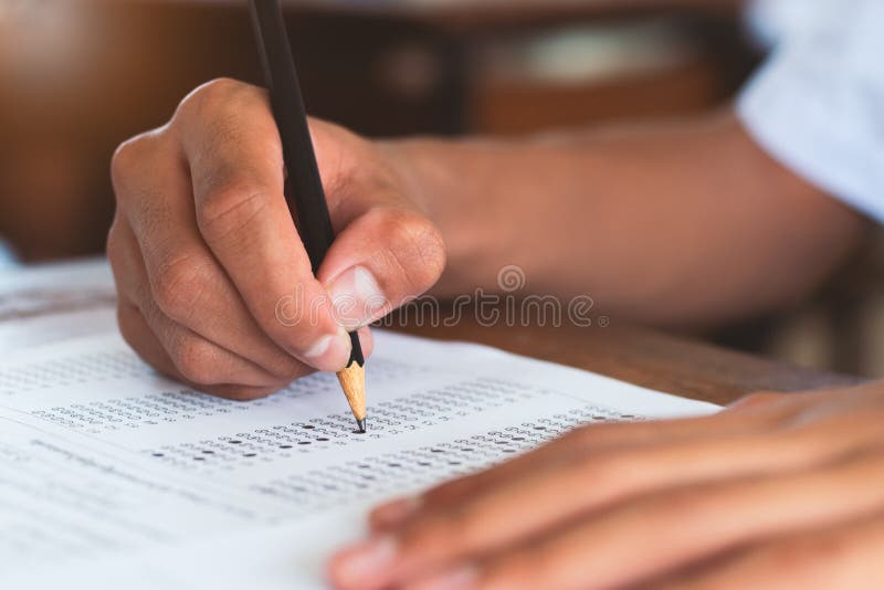 School Student is Taking Exam and Writing Answer in Classroom for ...