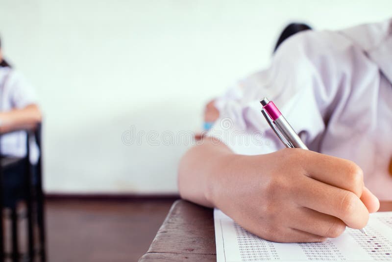 School Student is Taking Exam and Writing Answer in Classroom for ...