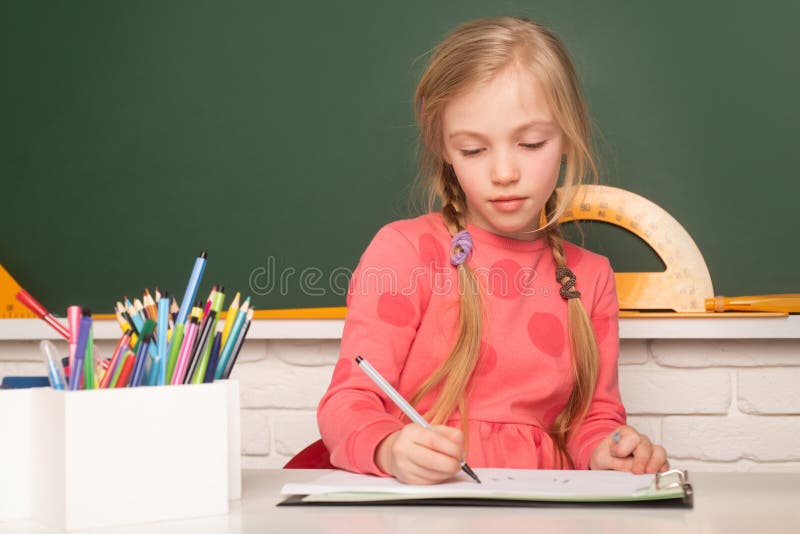 School Student Taking Notes from Book for Study. School Child Near ...