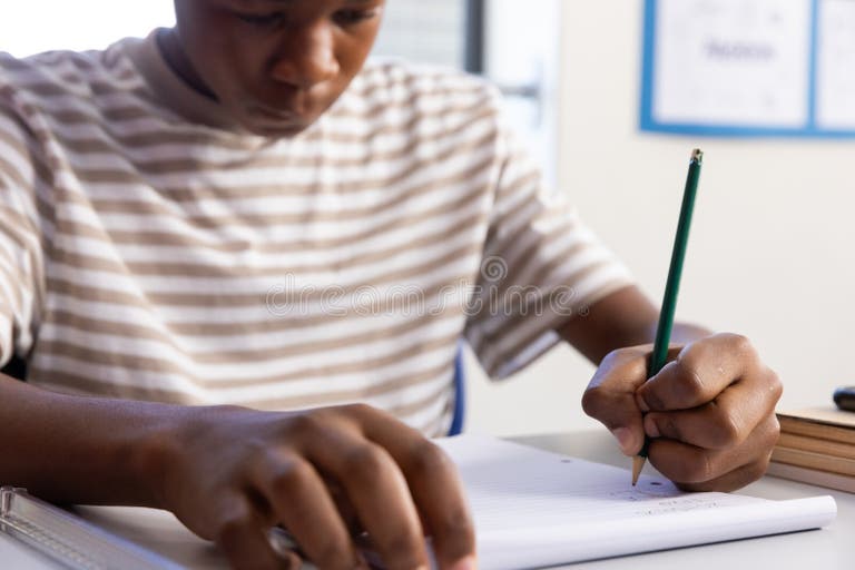 In School, Student Writing in Notebook, Focusing on Classroom ...