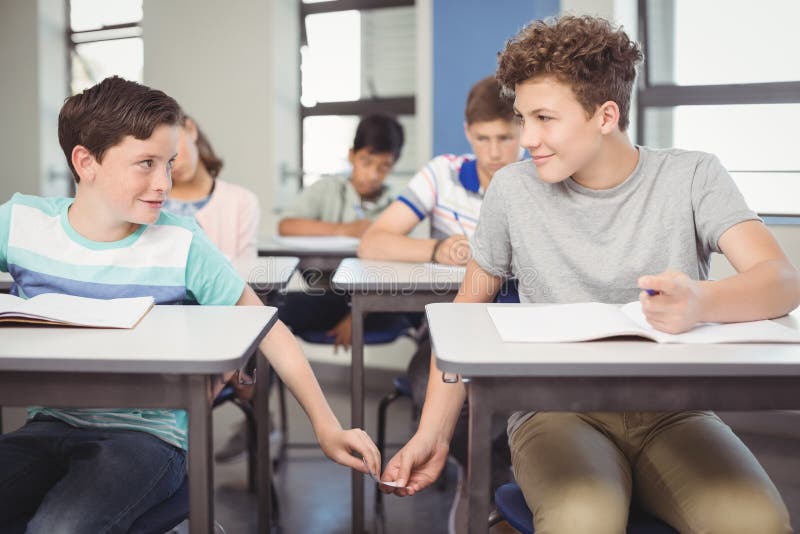 Students passing notes stock photo. Image of test, passing - 31009104