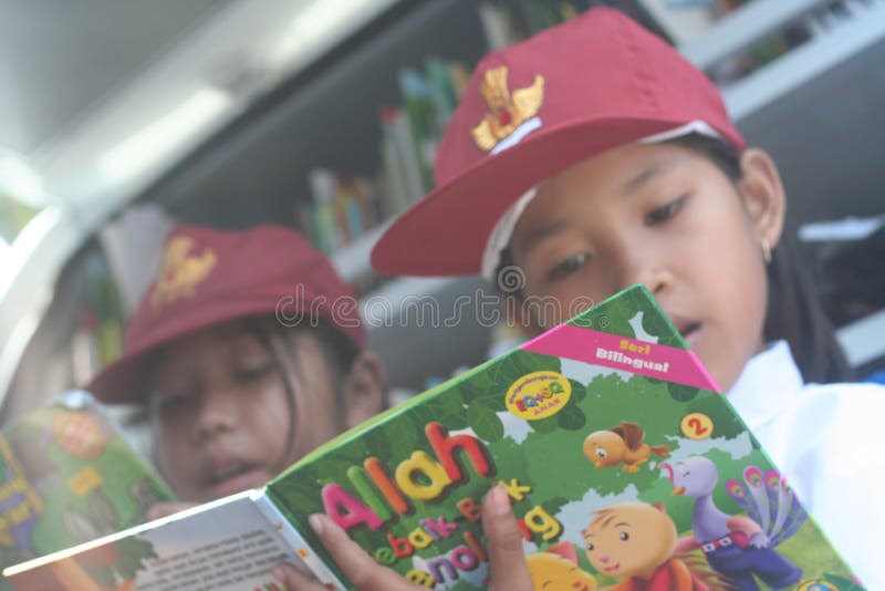 School Students Reading a Book in the Mobile Library Editorial Stock ...