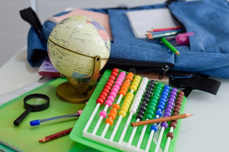 School Supplies on the Study Table, Backpack, Globe, Calculator ...