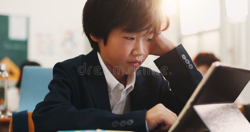 School, Tablet and Japanese Child with Reading, Learning and ...