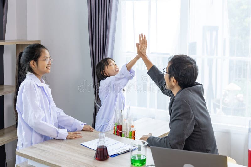School Teacher is Doing High Five with Students in Scientific Lab Gown ...