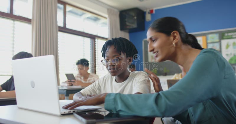 In School, Teacher Helping Student with Laptop in Classroom, Others ...