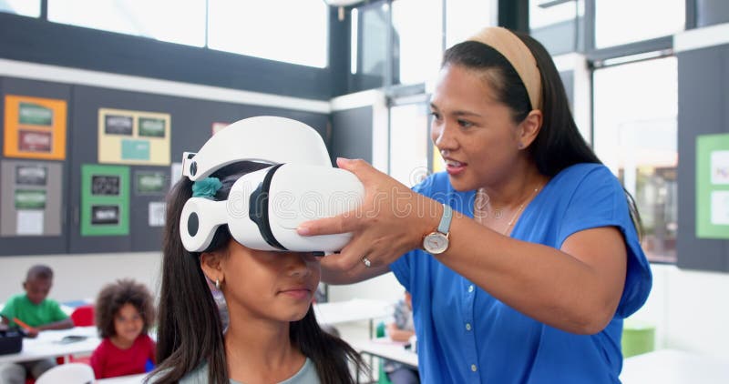 In School, Teacher Helping Student with Homework at Classroom Desk ...