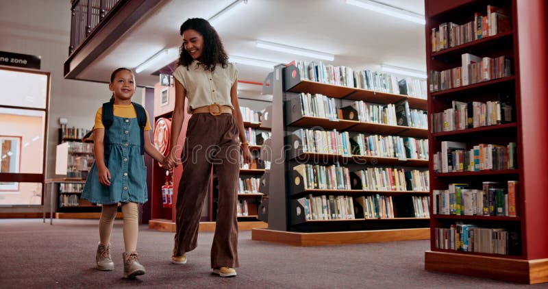 School, Teacher or Kid in a Library Walking with Smile for Knowledge or ...