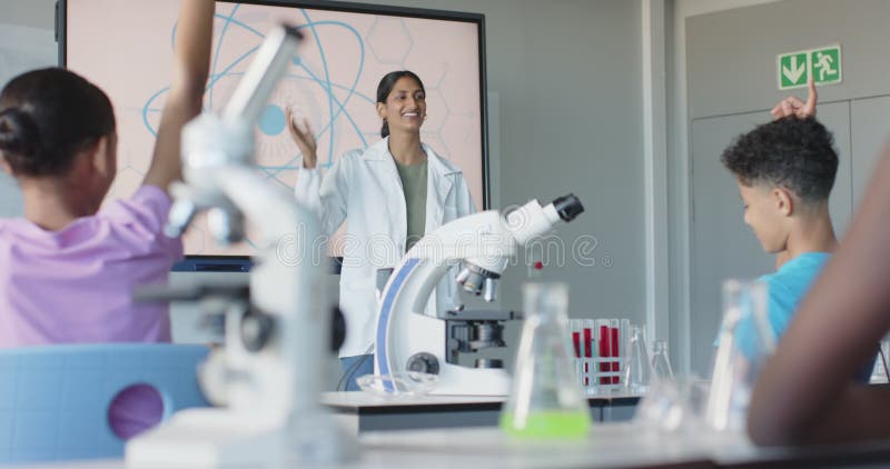 In School, Teacher in Lab Coat Engaging Students in Science Classroom ...