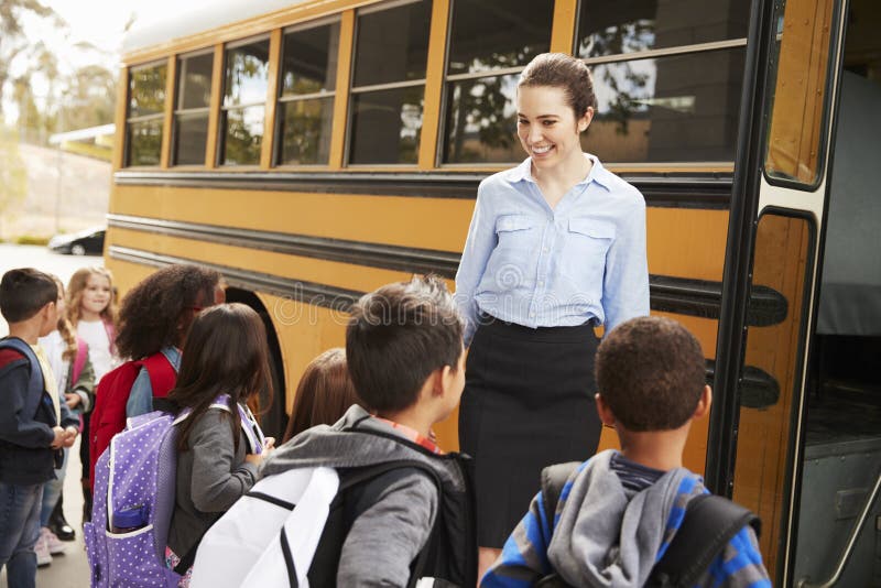 Two Girls at the Front of the Elementary School Bus Queue Stock Photo ...
