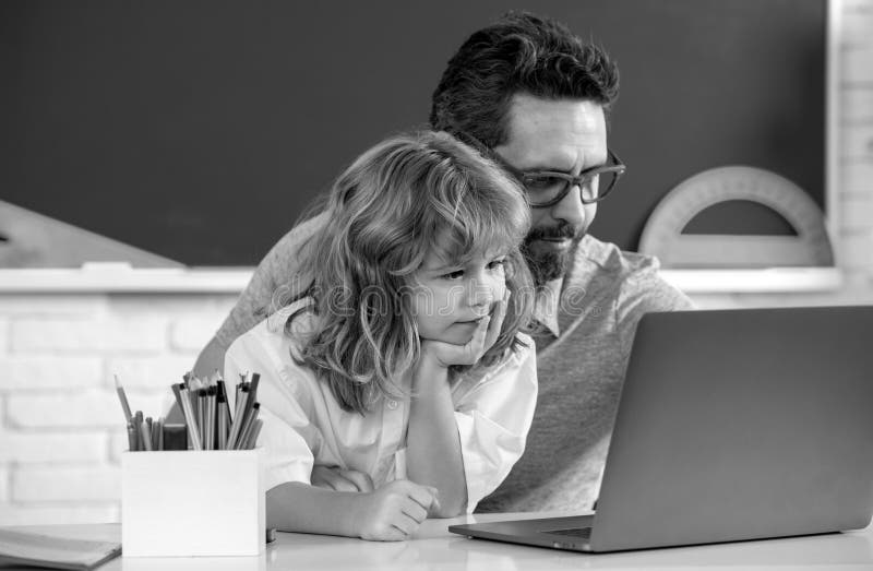 School Teacher with a Schoolboy Learning at Laptop Computer, Studying ...