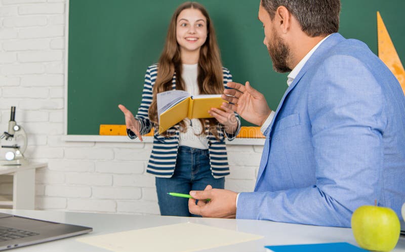 School Teacher with Selective Focus of Smiling Child at Blackboard ...