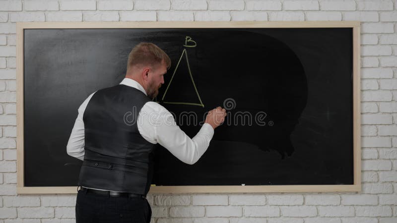 Man College Teacher in Classroom in Front of Chalkboard Explaining ...