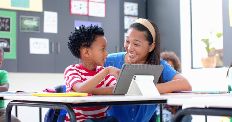 In School, Teacher and Student Using Tablet Together in Classroom ...