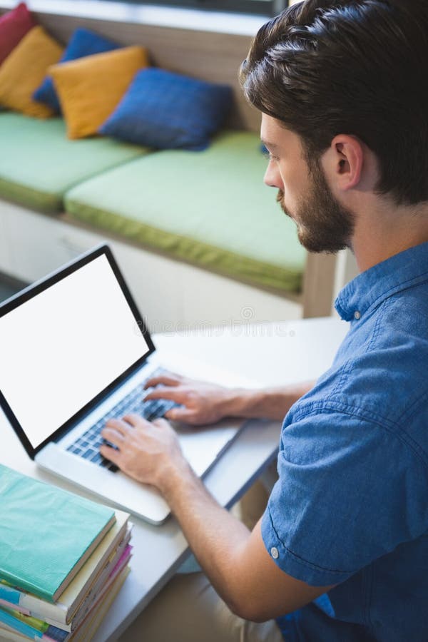 School Teacher Working on Laptop in Library Stock Photo - Image of ...