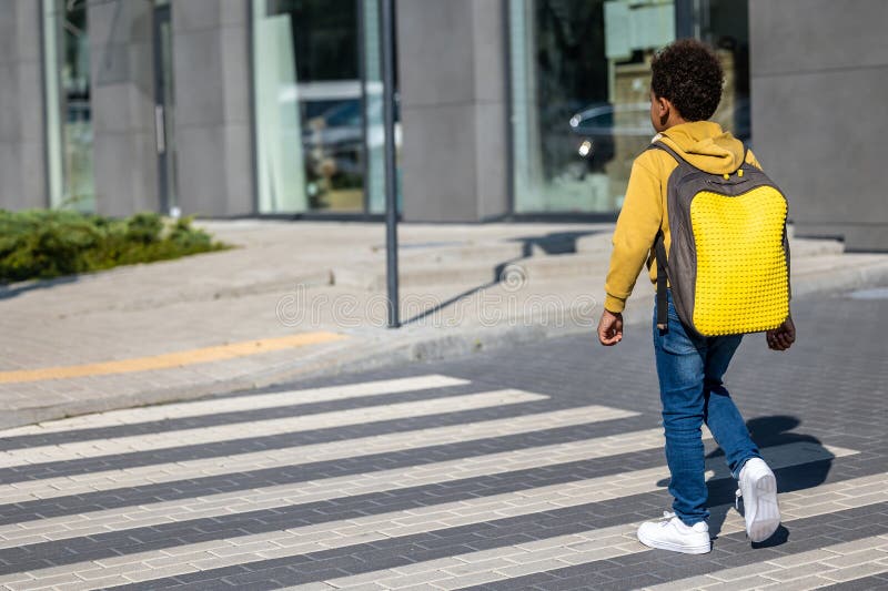 Schoolboy with Backpack on His Back Crossing the Street Stock Photo ...