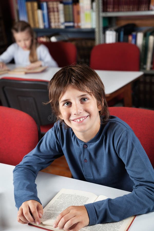 Schoolboy with Book Sitting in Library Stock Image - Image of classmate ...