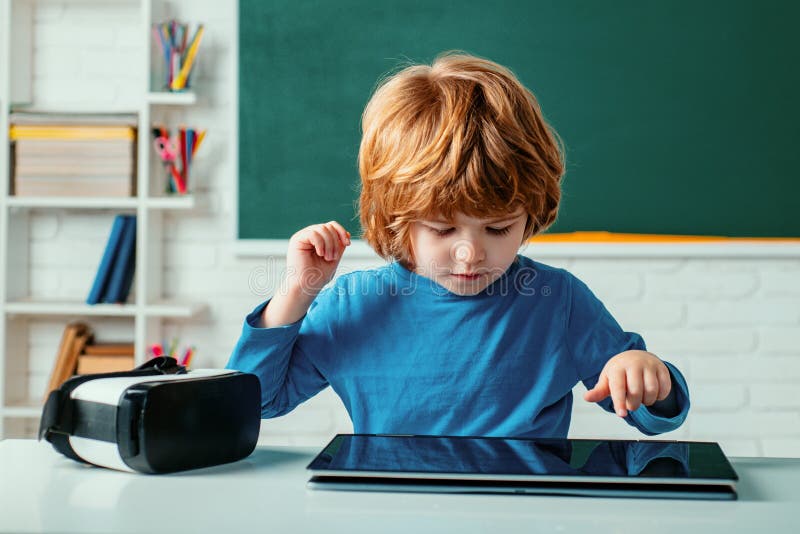 Schoolboy with Digital Tablet in School Classroom. Pupil in Class Using ...