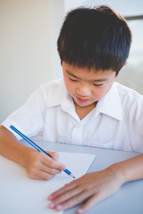 Schoolboy Doing Homework in Classroom Stock Photo - Image of learn ...