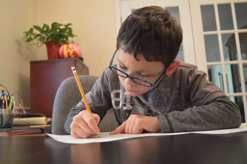 Schoolboy doing homework stock photo. Image of writing - 50401920