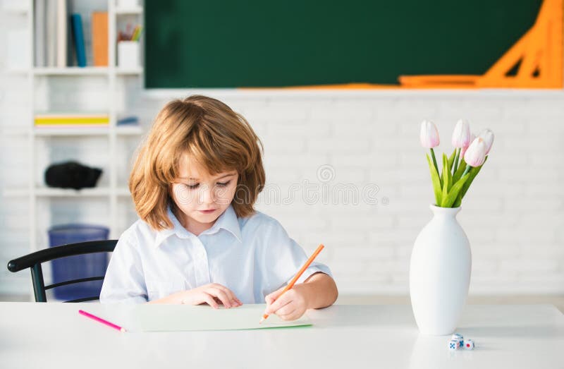 Schoolboy Doing Homework. School Kid Against Green Chalkboard. Gets ...