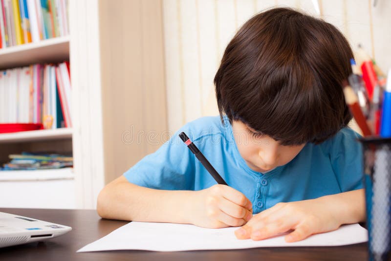 Schoolboy doing homework stock photo. Image of homework - 101969728