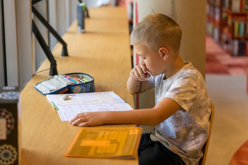 Schoolboy Doing Homework at a Table in the City Library Stock Image ...