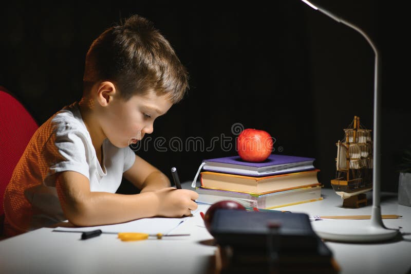 Schoolboy Doing Homework at the Table in His Room Stock Image - Image ...