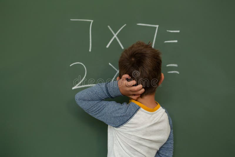 Schoolboy Doing Math on Greenboard in a Classroom Stock Image - Image ...