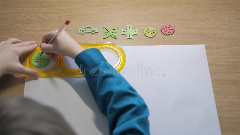 Child Performs a Drawing Using a Graphic Ruler, Pen and Template. Stock ...