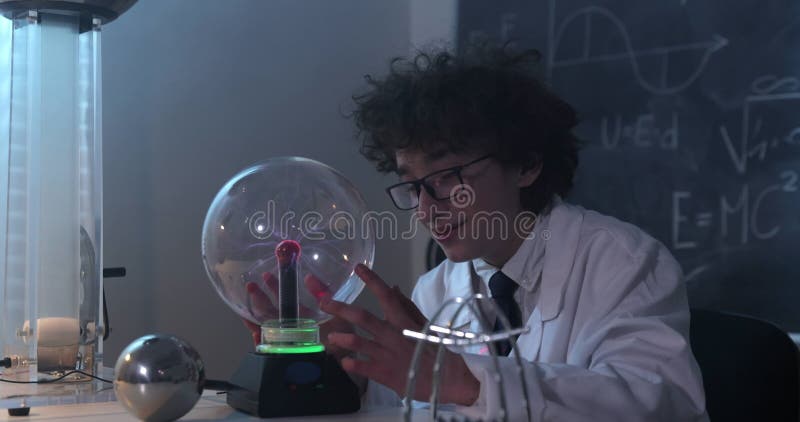 Schoolboy Experimenting in Physics Class. Young Student Doing Physics ...