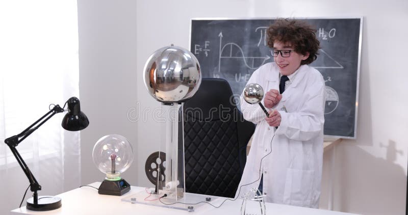 Schoolboy Experimenting in Physics Class. Young Student Doing Physics ...