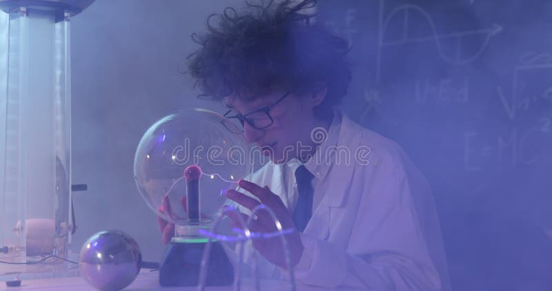 Schoolboy Experimenting in Physics Class. Young Student Doing Physics ...