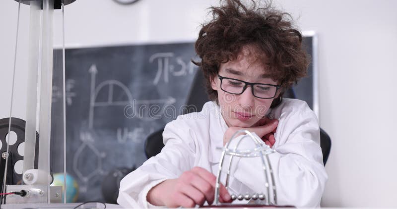 Schoolboy Experimenting in Physics Class. Young Student Doing Physics ...