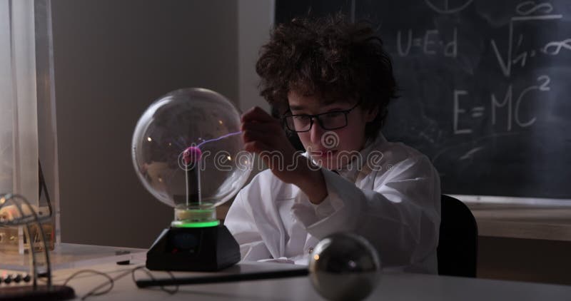 Schoolboy Experimenting in Physics Class. Young Student Doing Physics ...