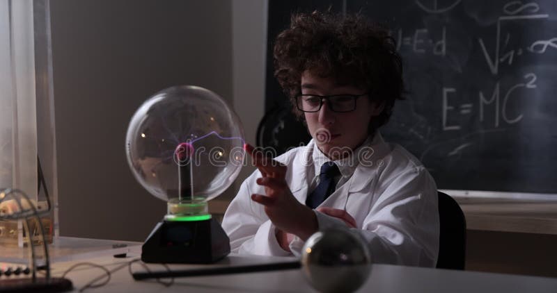 Schoolboy Experimenting in Physics Class. Young Student Doing Physics ...