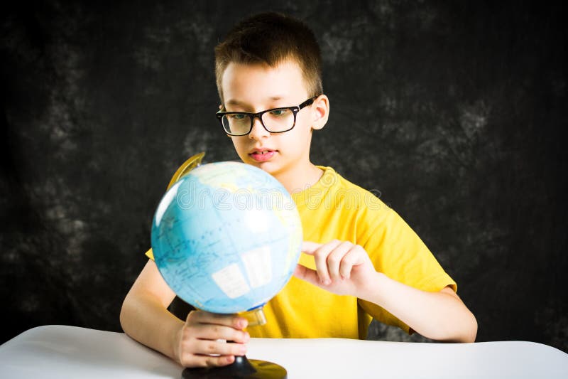 Schoolboy Exploring World through a Globe Stock Photo - Image of school ...