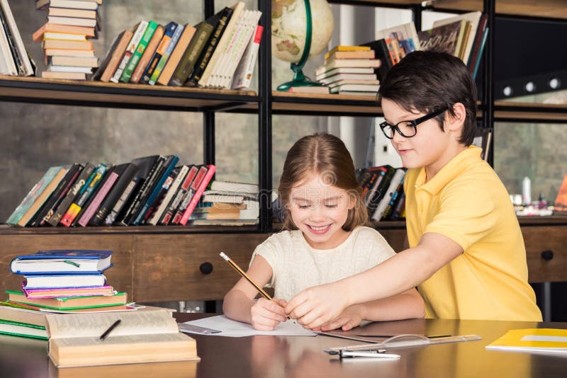 Schoolboy in Eyeglasses Helping Classmate in Doing Homework Stock Image ...