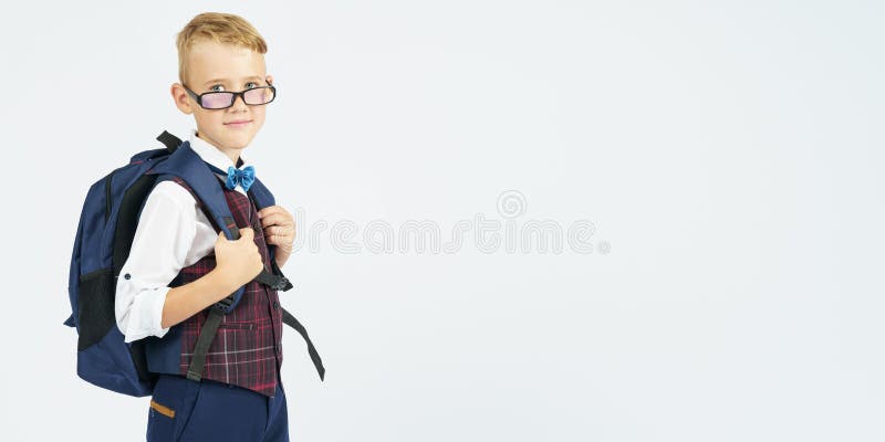 A Schoolboy Holds a School Backpack, Stands Sideways, Looks at the ...