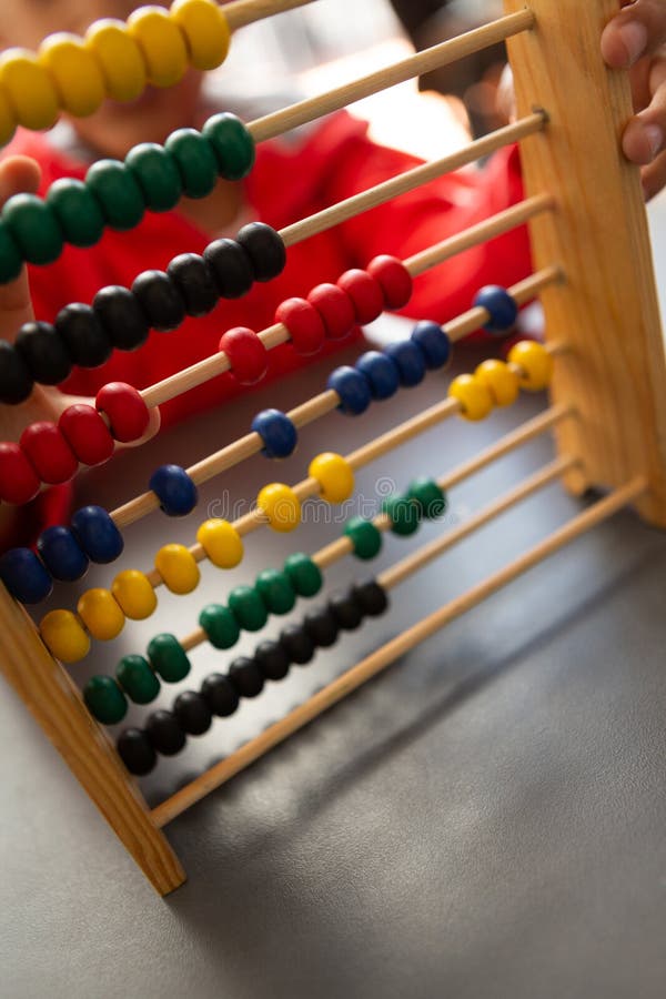 Schoolboy Learning Math with Abacus at Desk in a Classroom Stock Photo ...