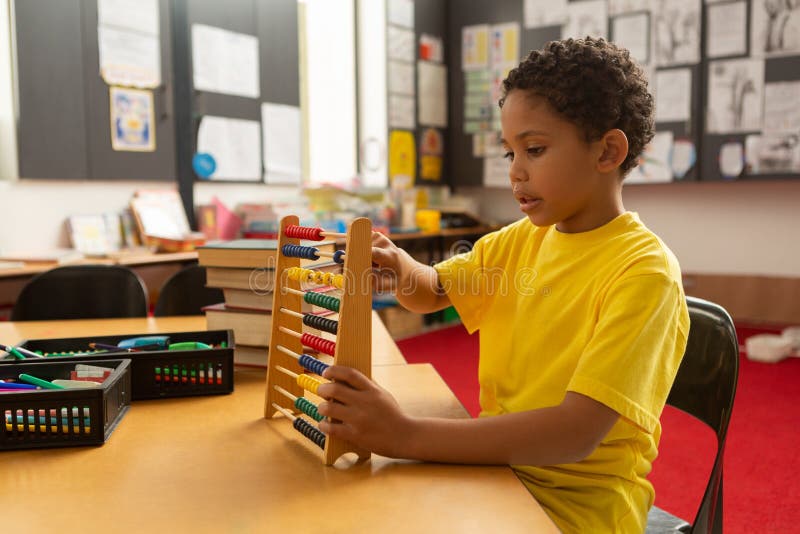 Schoolboy Learning Mathematics with Abacus in a Classroom Stock Photo ...